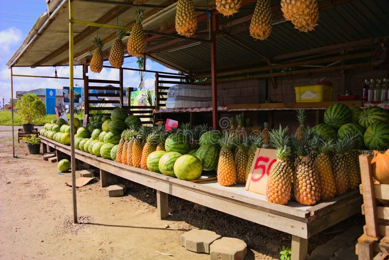 A Display of Pineapples, Melons and Other Fruit on Top of Tables Stock ...