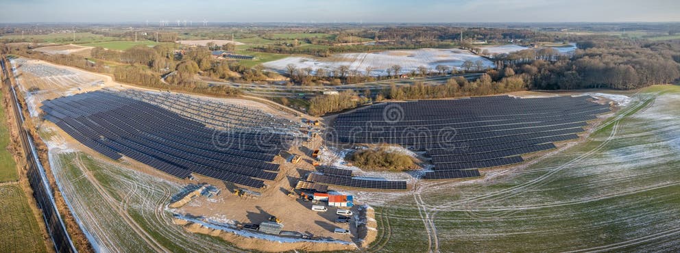Array of Solar Panels Arranged in Neat Rows, with Construction Vehicles ...