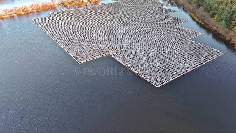 An Array of Solar Panels Floating in Water in a Large Pond Generating ...