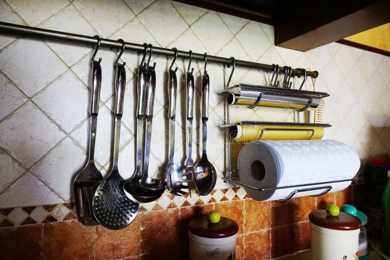 An Array of Stainless Steel Kitchen Utensils Hanging on a Metal Rack ...