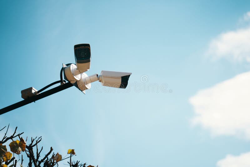 An Array of Surveillance Cameras Positioned Against a Clear Blue Sky ...
