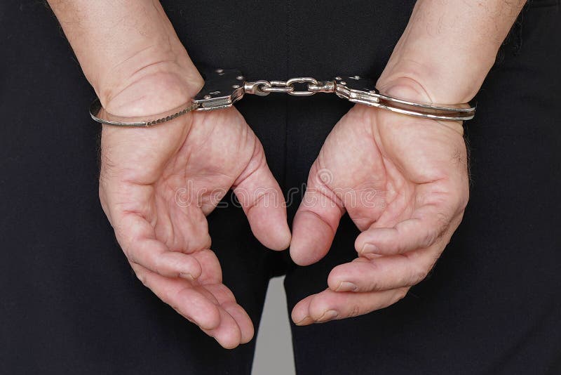Arrested Man in Handcuffs with Hands Behind Back Stock Image - Image of ...