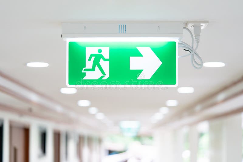 A Arrow Light Box Sign of EMERGENCY FIRE EXIT is Hung on the Ceiling in ...