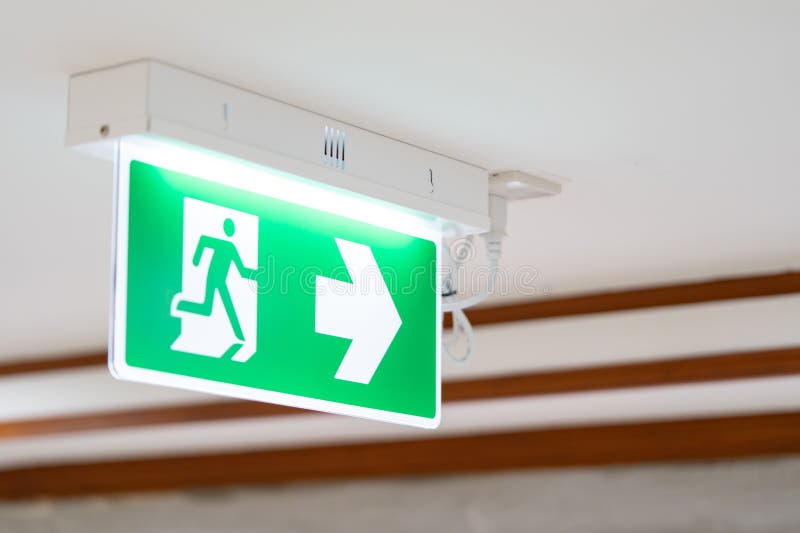 A Arrow Light Box Sign of EMERGENCY FIRE EXIT is Hung on the Ceiling in ...