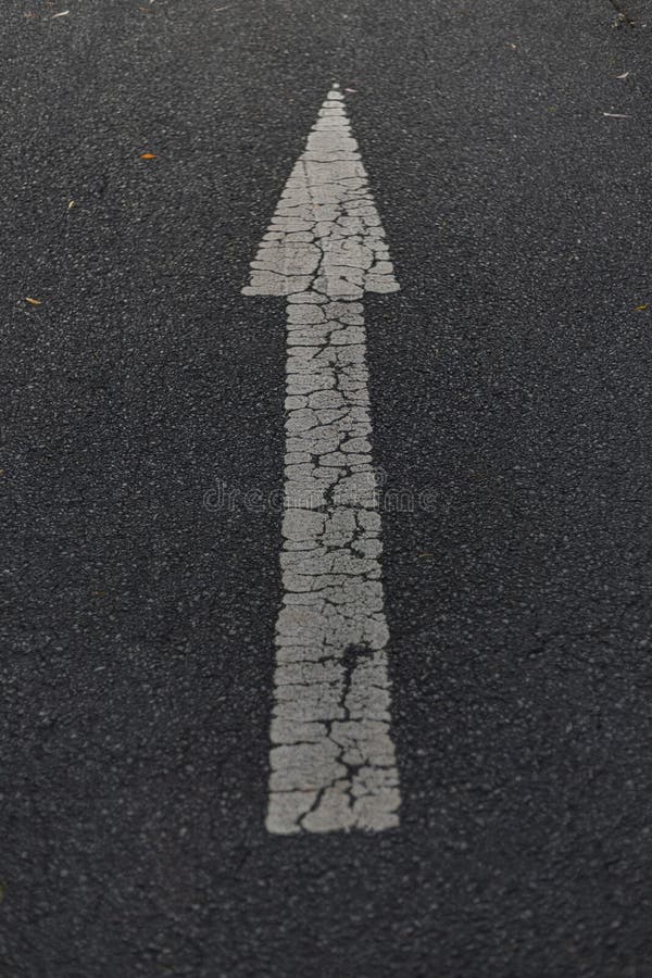 An arrow sigh on asphalt stock photo. Image of eroded - 266009522