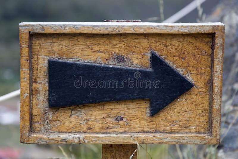 Arrow sign on wooden post stock photo. Image of panel - 137745098