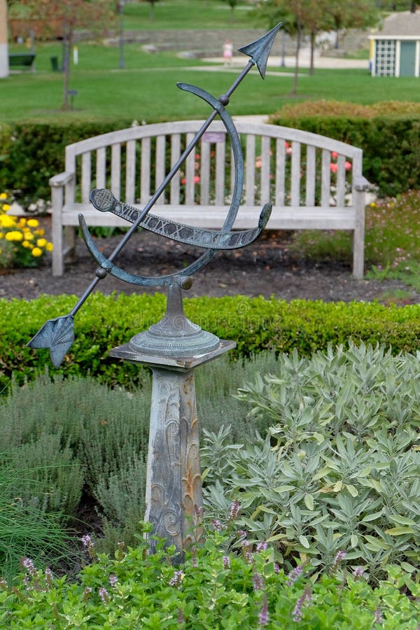 Arrow Sundial stock photo. Image of yard, surrounded - 71103636