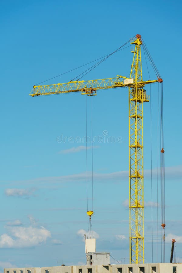 An Arrow of Working Construction Cranes Against a Background of Blue ...