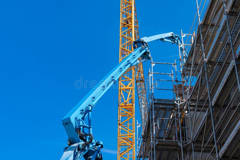Arrows of Blue and Yellow Construction Cranes on the Background of ...