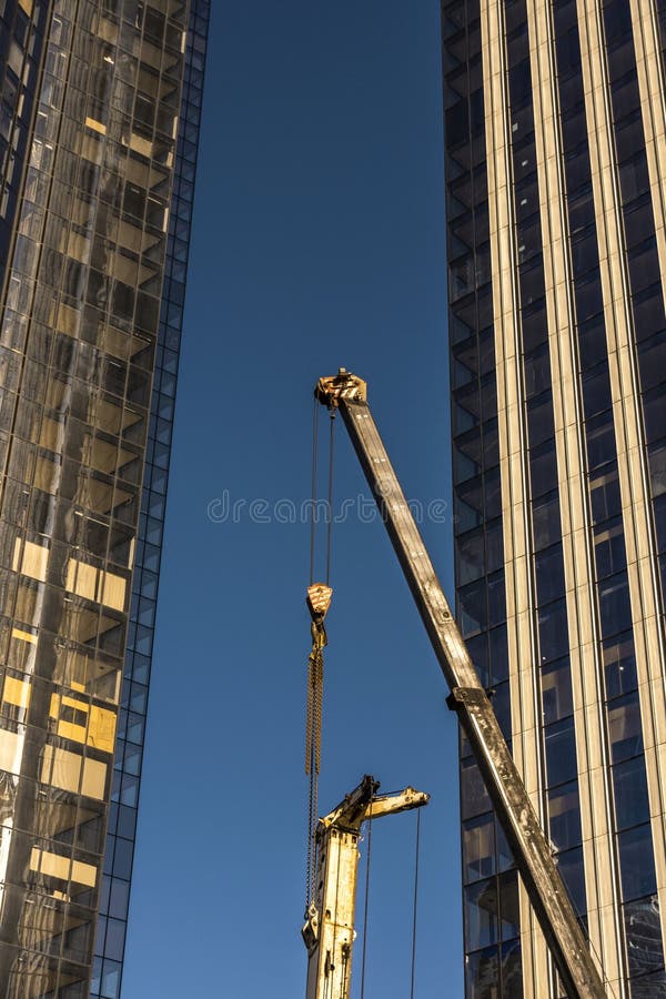 Arrows of Construction Cranes on the Background of a High-rise ...