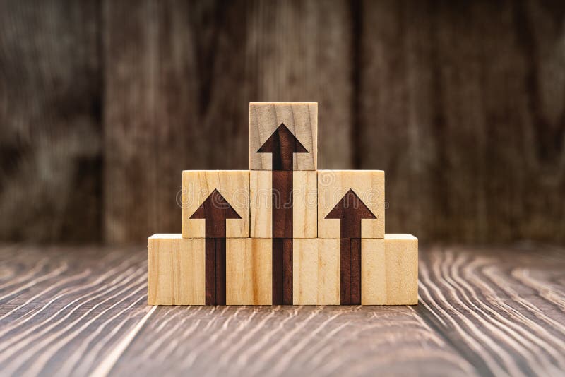 Arrows Pointing Up on Stack of Wooden Blocks Stock Image - Image of ...