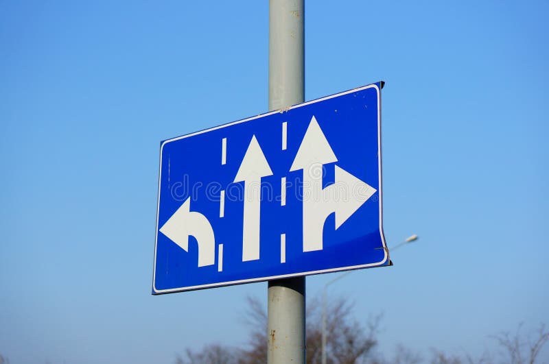 Road Sign with Arrows in Two Different Directions Stock Photo - Image ...