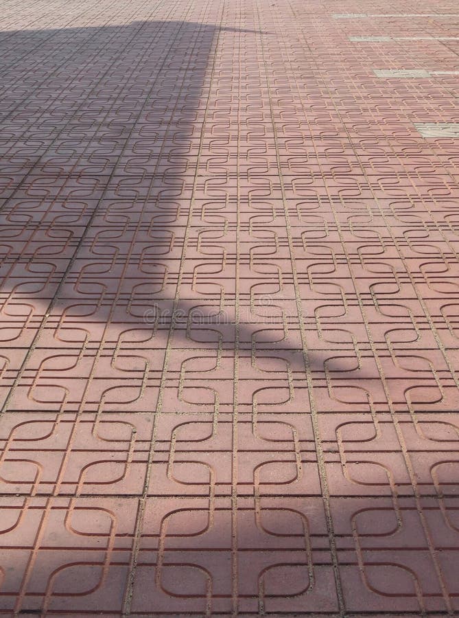 Light and Shadow Cast on the Patterned Tiled Pavement Stock Image ...