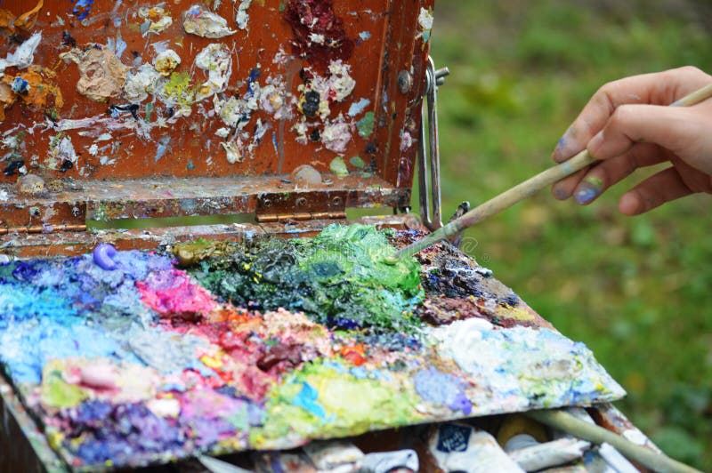 Art easel with paints stock image. Image of indoors - 253895109