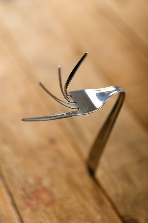 Art of Fork Bending, How To Bend Forks with Your Mind Stock Photo ...