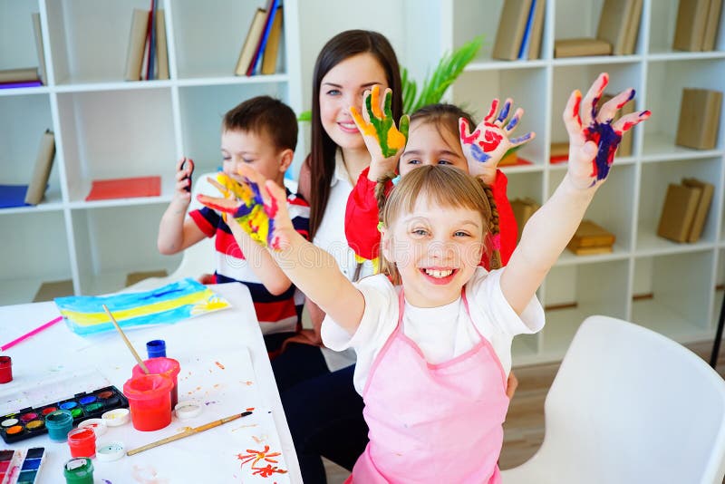 Art lesson in kindergarten stock image. Image of instructor - 91726243