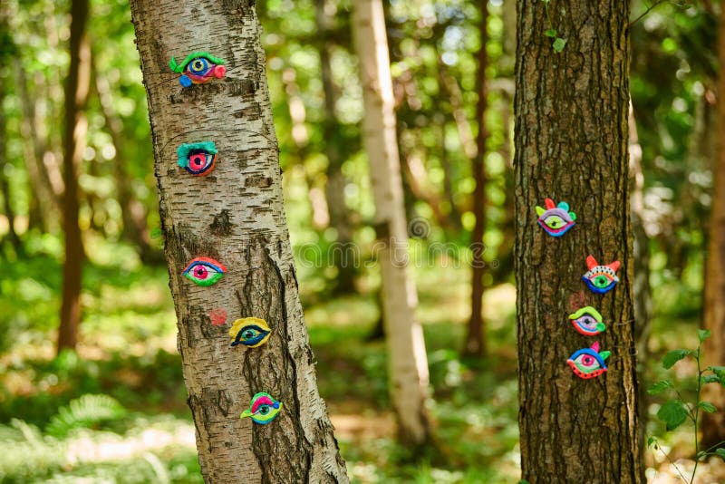 Art Object of Human Eyes on Tree Trunk in Green Forest Background ...