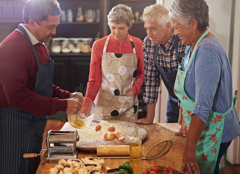 The Art of Pasta. a Group of Seniors Cooking in the Kitchen. Stock ...