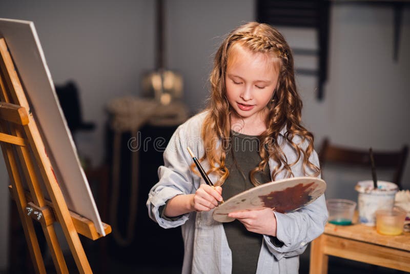 An Art School Student Mixes Colors on a Palette for Her Canvas Drawing ...