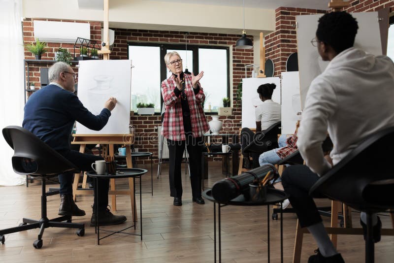 Art Teacher Explaining Draw Technique To Diverse Team during Art Lesson ...