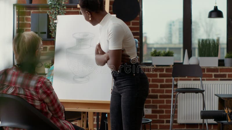 Art Teacher Training Senior Woman To Draw Artwork in Art Class Stock ...