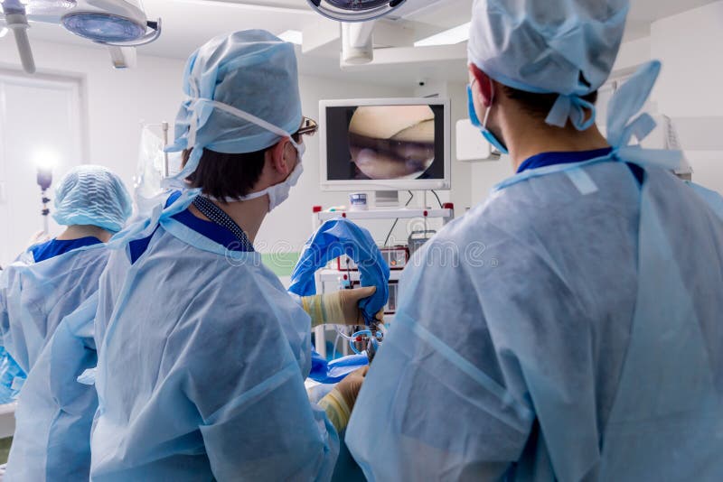 Arthroscope Surgery. Orthopedic Surgeons in Teamwork in the Operating ...