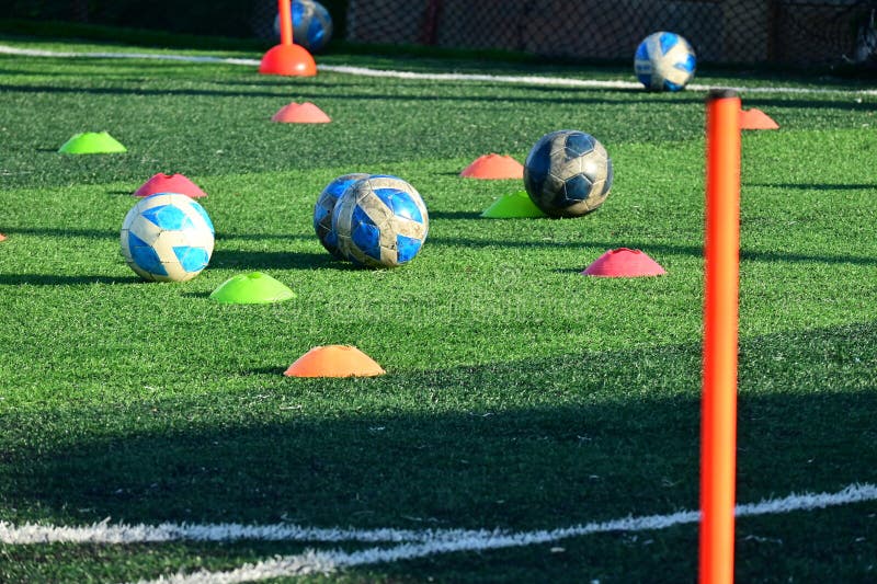 Artificial Green Grass Soccer Field with Training Cone and Ball Stock ...