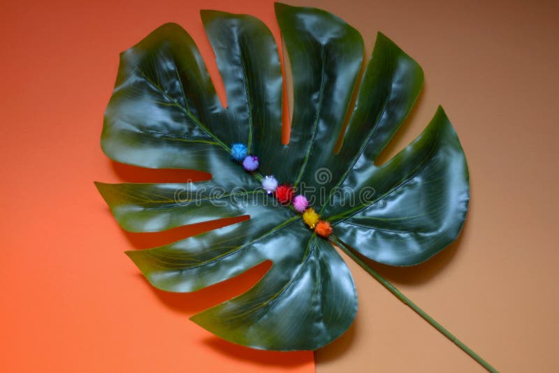 Plastic Leaf on Paper Background. Stock Photo - Image of colored, balls ...