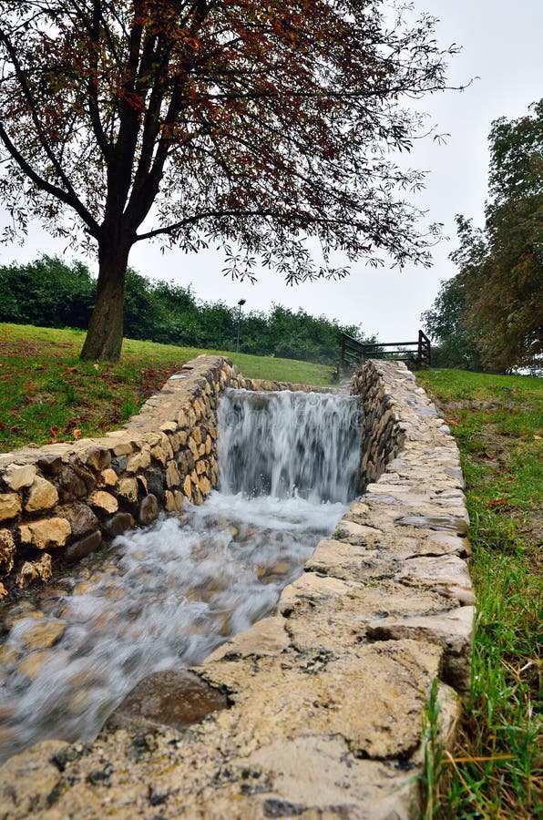 Artificial stream stock photo. Image of moss, cool, waterfall - 46993678 Artificial stream stock photo. Image of moss, cool, waterfall - 46993678
