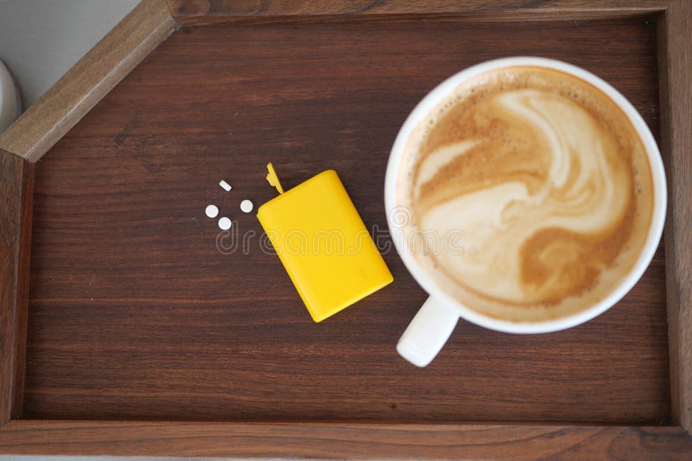 Artificial Sweetener Container and a Coffee on Table Stock Image ...