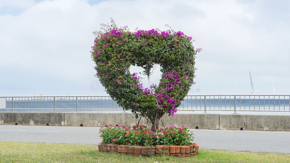Artificial Tree Planting Heart-shaped Flowers in the Ground Using a ...