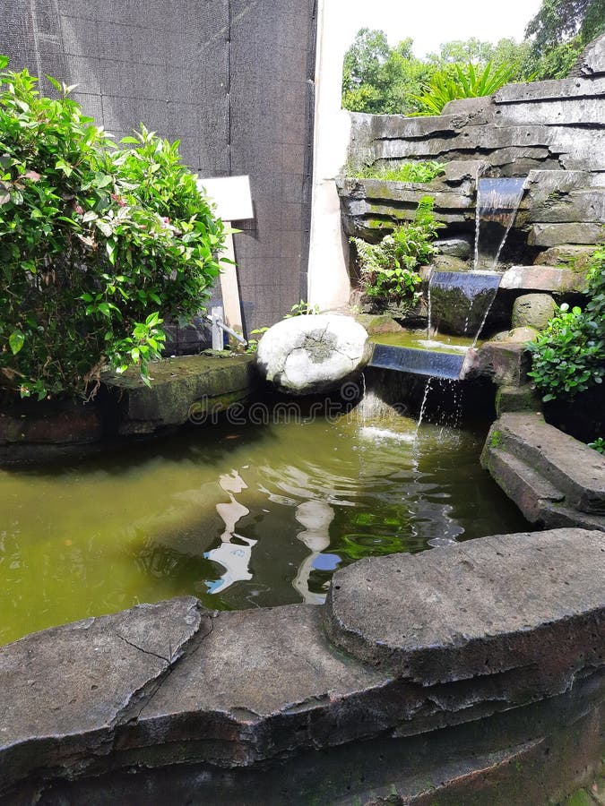 An Artificial Waterfall is Above the Fish Pond Stock Image - Image of ...
