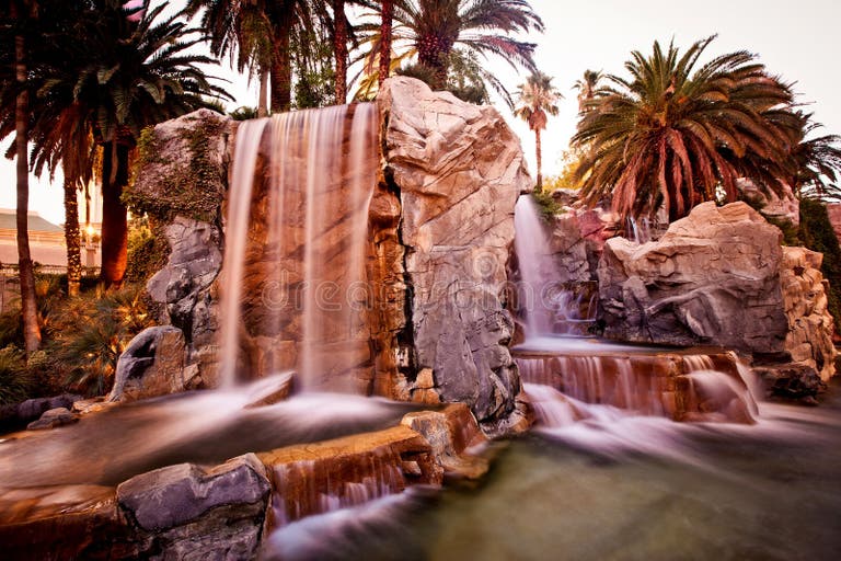 Artificial Waterfall with Palm Trees Stock Photo - Image of long, hotel ...