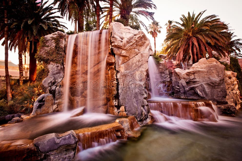 Artificial Waterfall with Palm Trees Stock Photo - Image of long, hotel ...