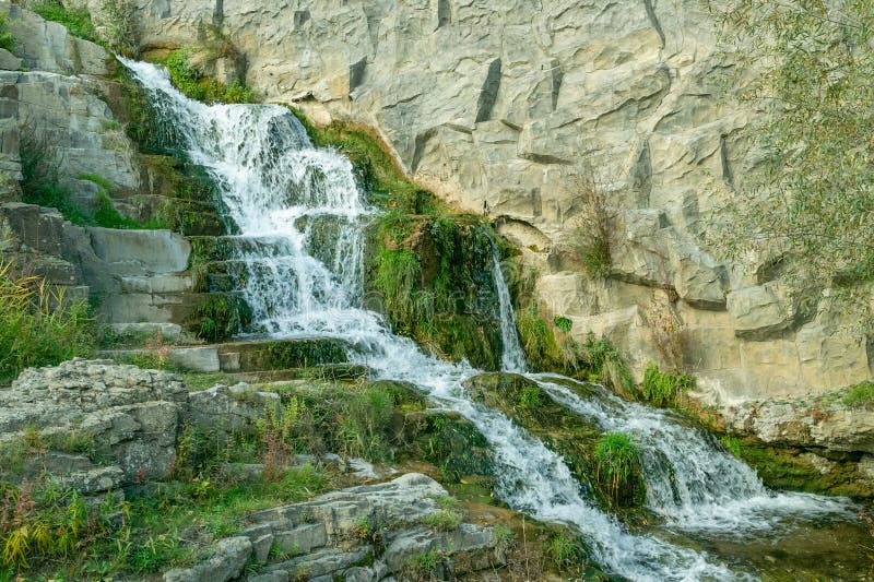 Artificial Waterfall in the Park. Flow of Water in the River Stock ...