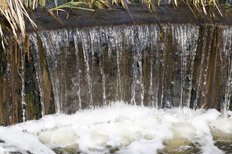 Artificial waterfall stock image. Image of footbridge - 130506935
