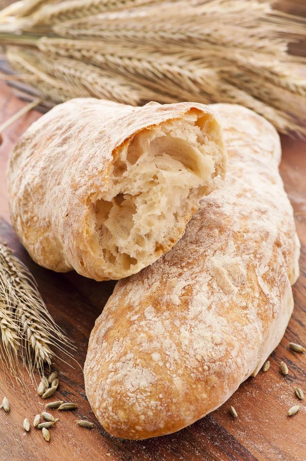 Artisan Bread on a Wooden Tabled Stock Image - Image of coarse, crumb ...
