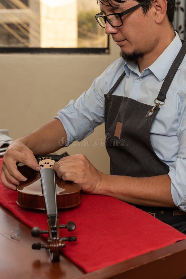 Artisan Fixing the Bridge of a Violin in a Workshop Stock Image - Image ...