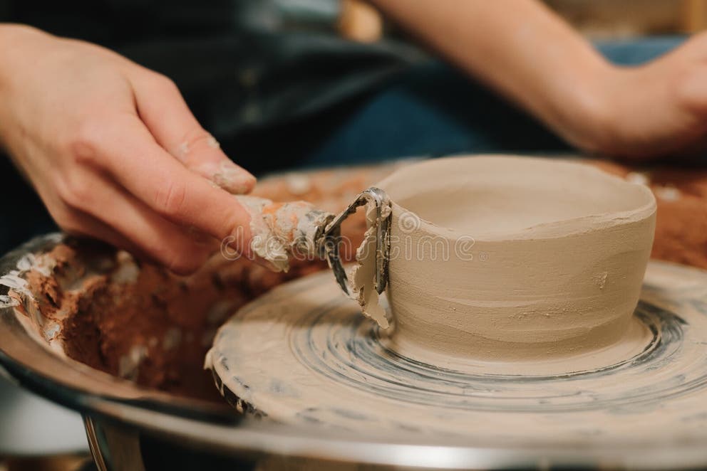 Artisan Forms Clay Pot with Potters Tool on the Spinning Wheel ...
