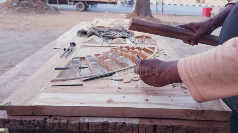 Artisan Hands Carving Wood with Chisel on Workbench with Tools and Wood ...