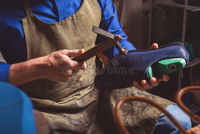 Artisan Holding a Boot and Hammer Stock Photo - Image of factory ...