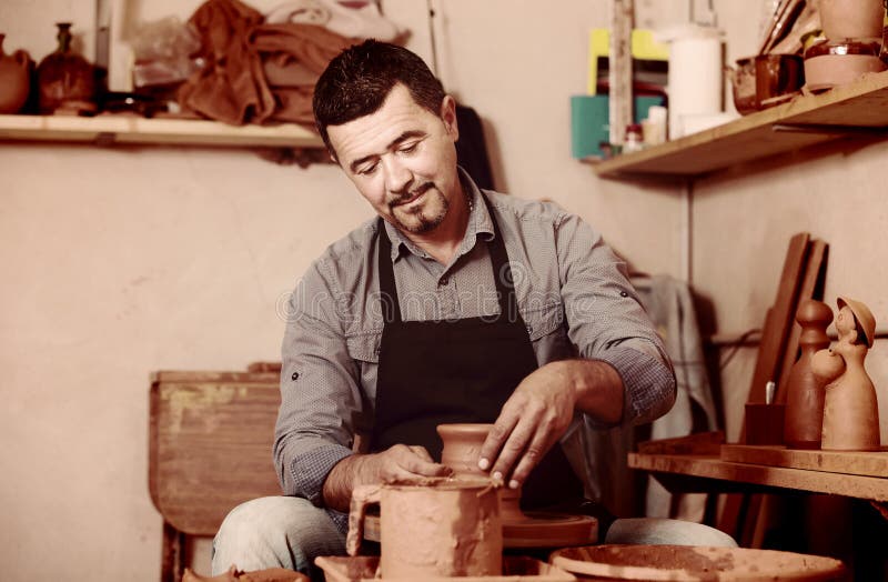 Artisan Man Creating Ceramic Piece on Spinning Pottery Wheel in Stock ...