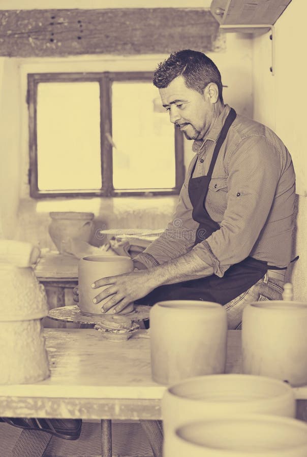 Artisan Man Creating Ceramic Piece on Spinning Pottery Wheel in Stock ...