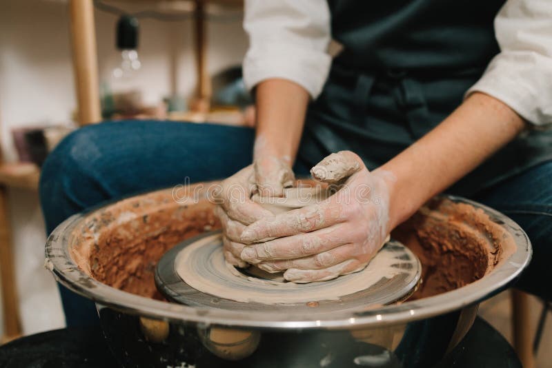 Artisan Molds a Piece of Wet Clay on the Pottery Wheel. Process of ...
