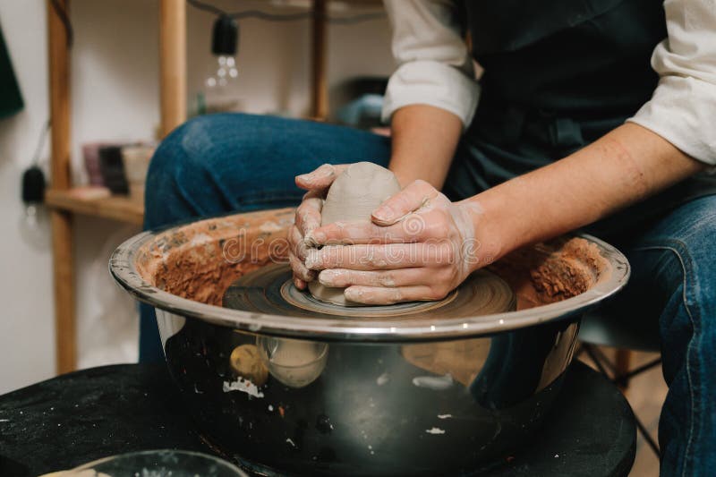 Artisan Molds a Piece of Wet Clay on the Pottery Wheel. Process of ...