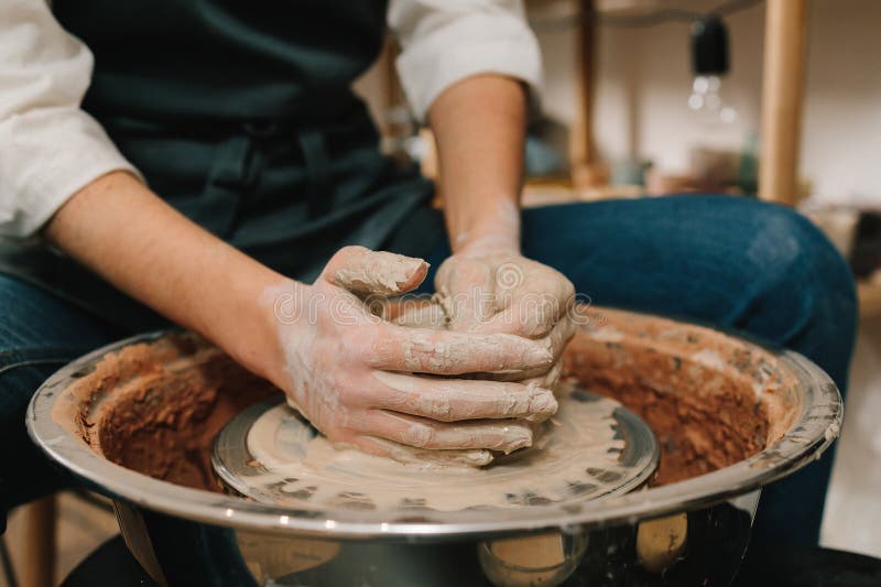 Artisan Molds a Piece of Wet Clay on the Pottery Wheel. Process of ...