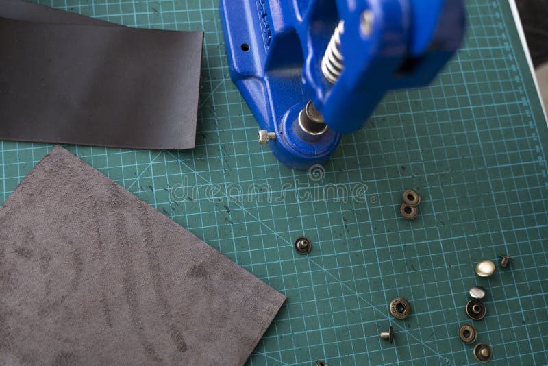 Artisan Using Hand Press for Setting Snaps in Leather for Makes a ...