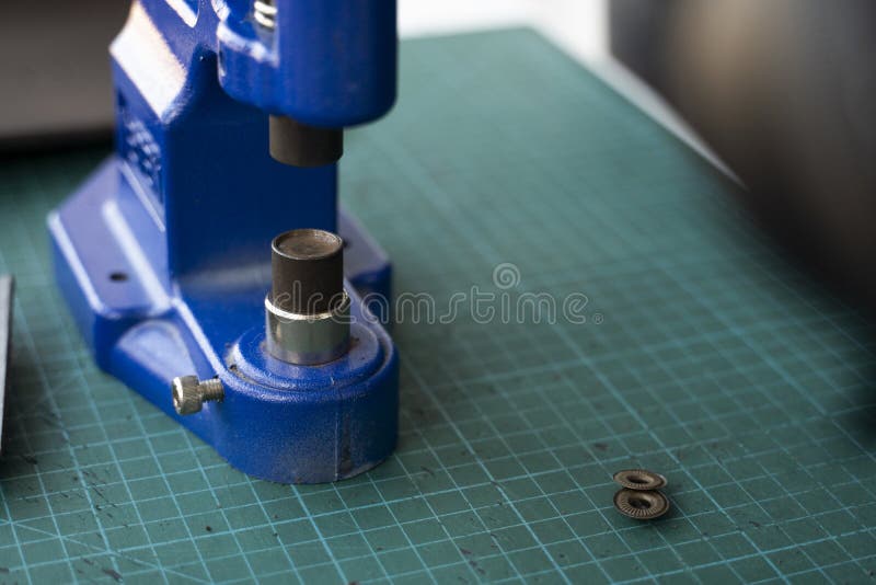 Artisan Using Hand Press for Setting Snaps in Leather for Makes a ...