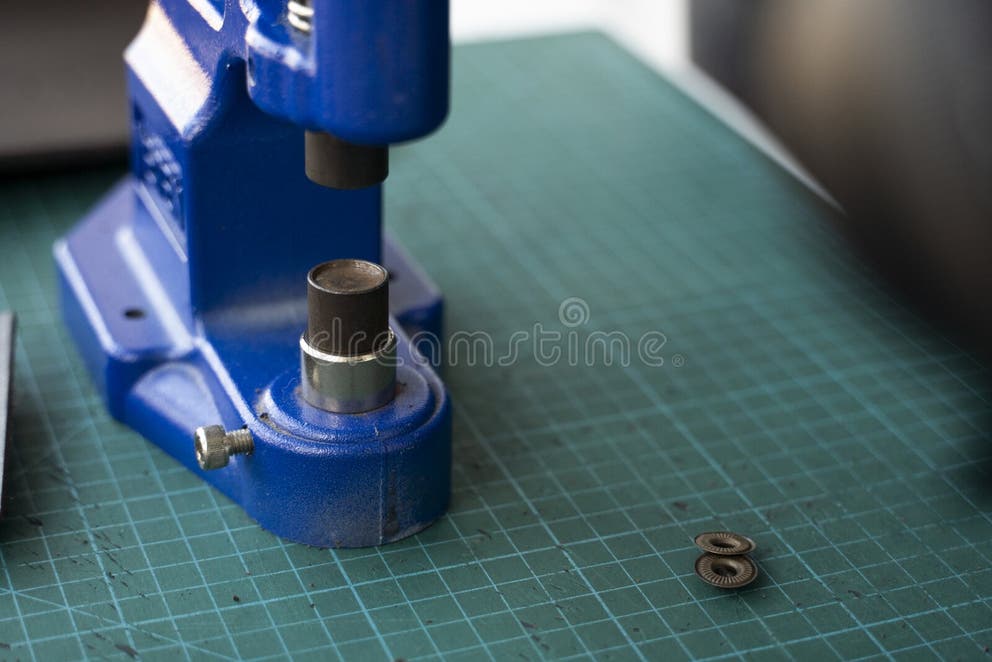 Artisan Using Hand Press for Setting Snaps in Leather for Makes a ...