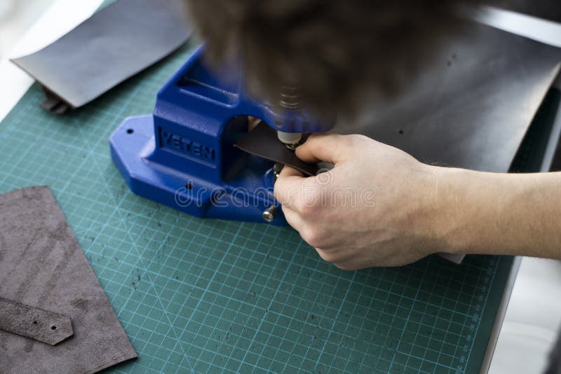 Artisan Using Hand Press for Setting Snaps in Leather for Makes a ...